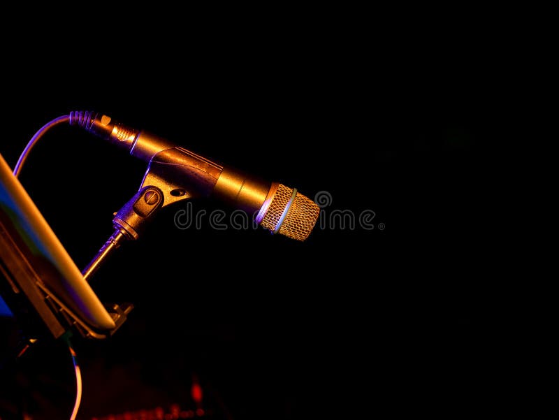 Microphone on One Side during a Concert Illuminated by Orange Colored ...