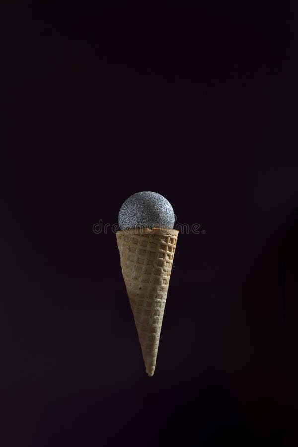 A Microphone is Placed Inside of an Ice Cream Cone. the Cone is Upside ...
