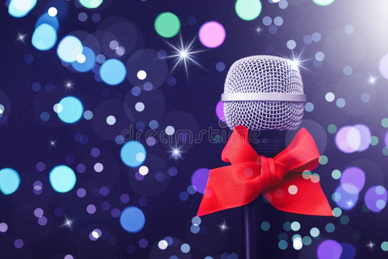 Microphone with Red Bow Against Blurred Lights, Space for Text ...