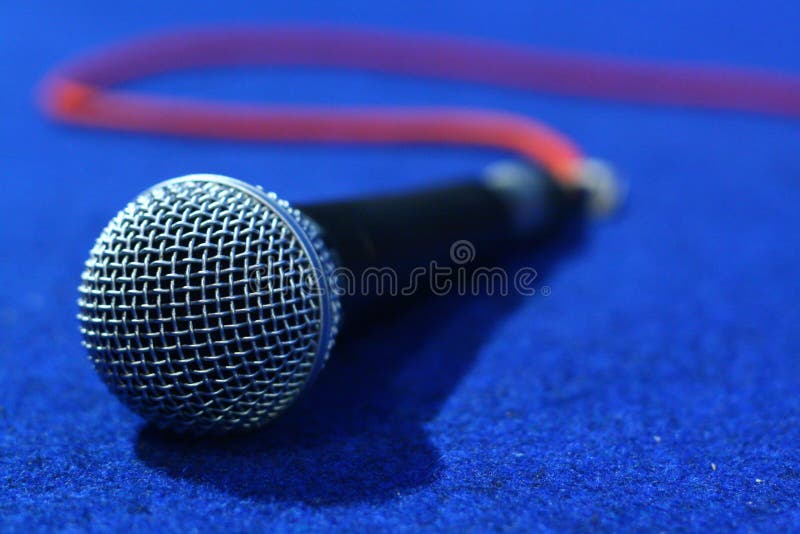 Microphone with Red Wire on Blue Carpet Stock Image - Image of ...
