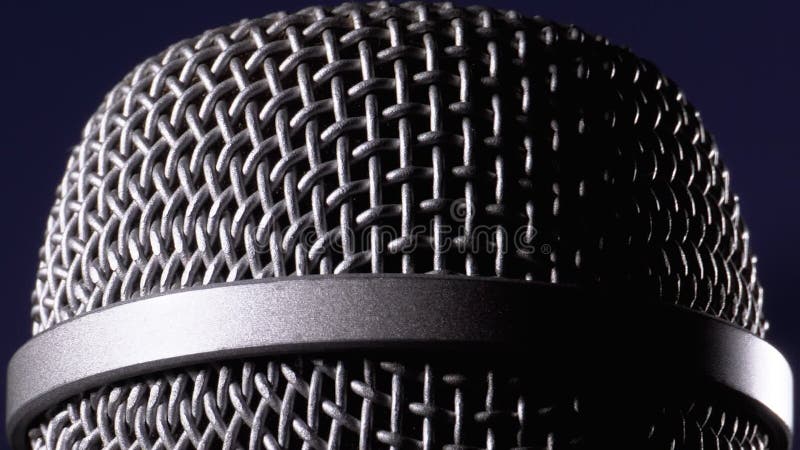 The Microphone Rotates on a Black Background. Dynamic Microphone Grid ...