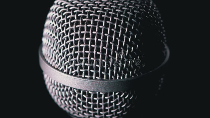 The Microphone Rotates on a Black Background. Dynamic Microphone Grid ...