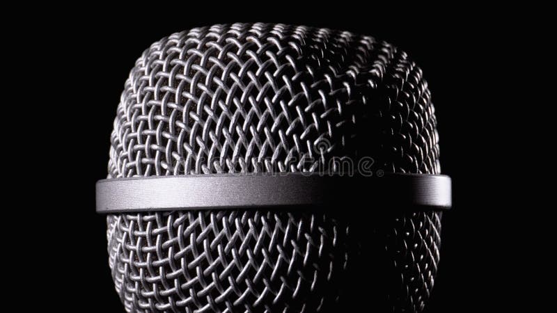 The Microphone Rotates on a Black Background. Dynamic Microphone Grid ...