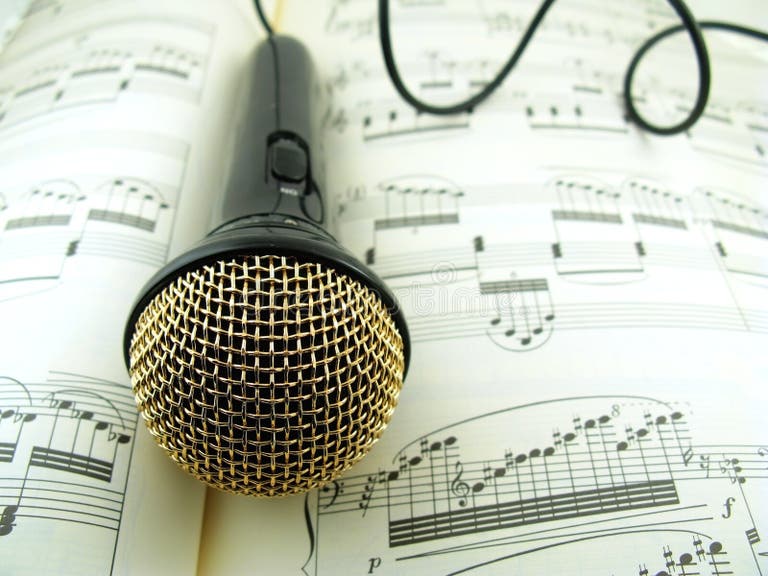 Microphone on sheet music stock photo. Image of note - 16691188