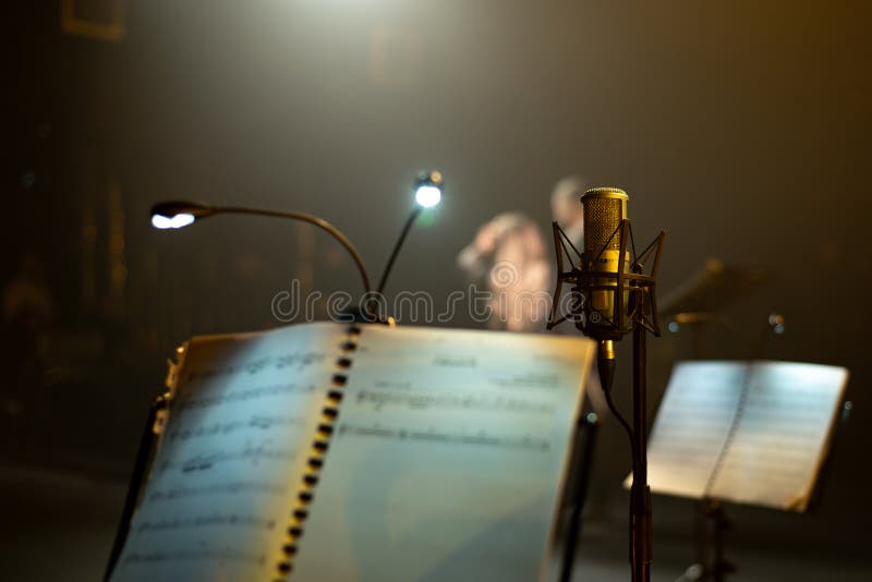 Microphone and Sheet Music in a Dimly Lit Studio during a Live ...
