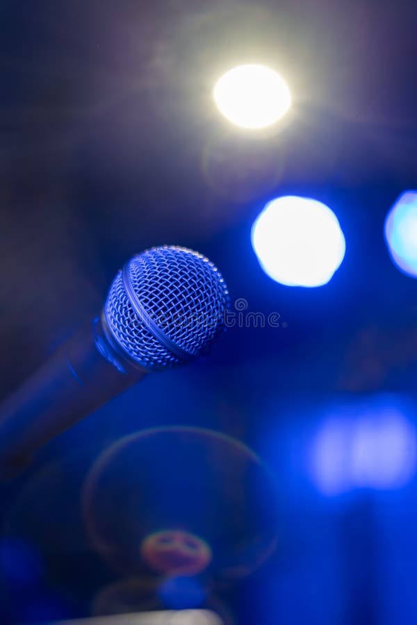 Microphone on Stage with Blue Lights Stock Image - Image of singing ...