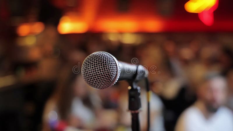 Microphone on Stage with Blurred Audience in Background. a Close-up of ...