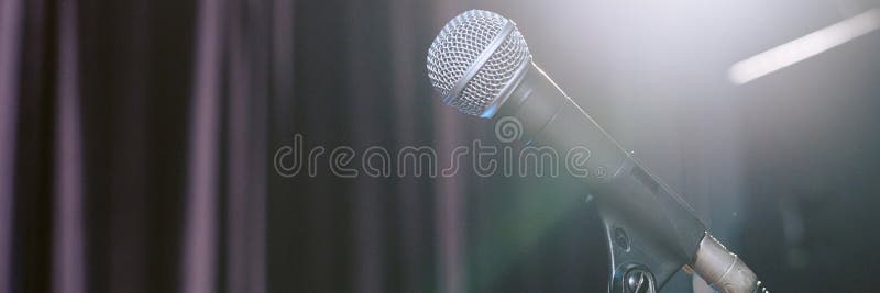 Microphone on Stage in Spotlight with Curtain Background Stock Photo ...