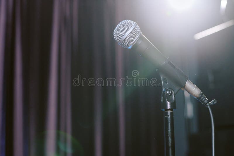 Microphone on Stage with Spotlight and Curtains Background Stock Image ...