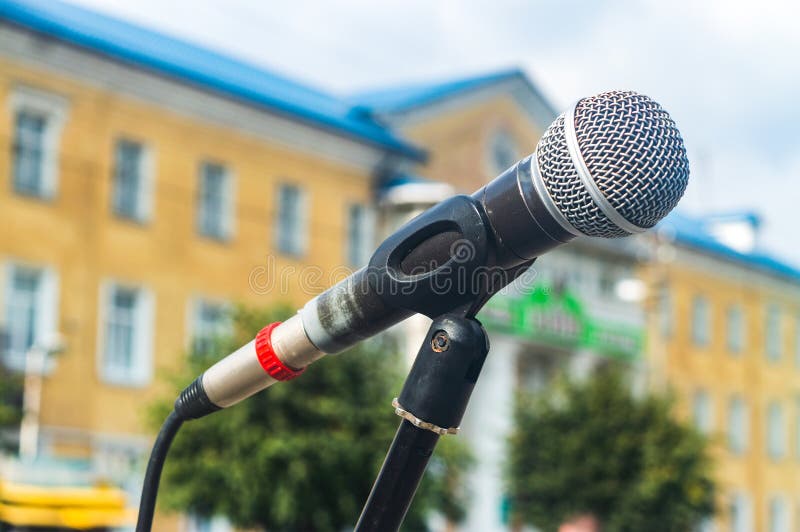 Microphone on a Stand Building in the Background Stock Photo - Image of ...