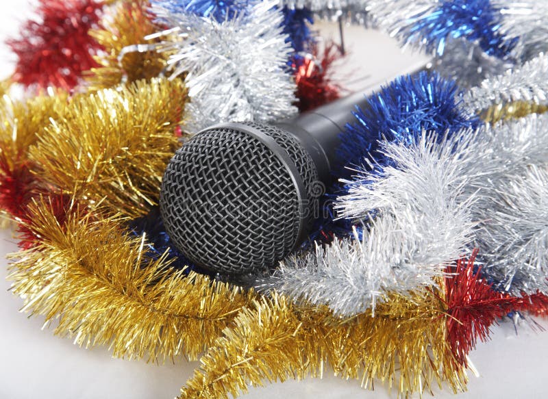Microphone with Red Bow and Fir Branches Against Blurred Lightst ...