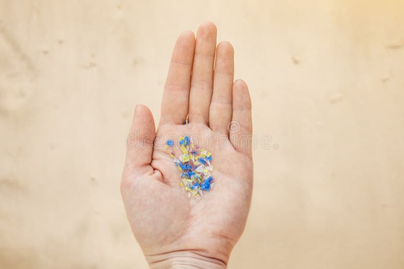 Microplastic in the Hand of a Man on the Beach. Environmental Pollution ...