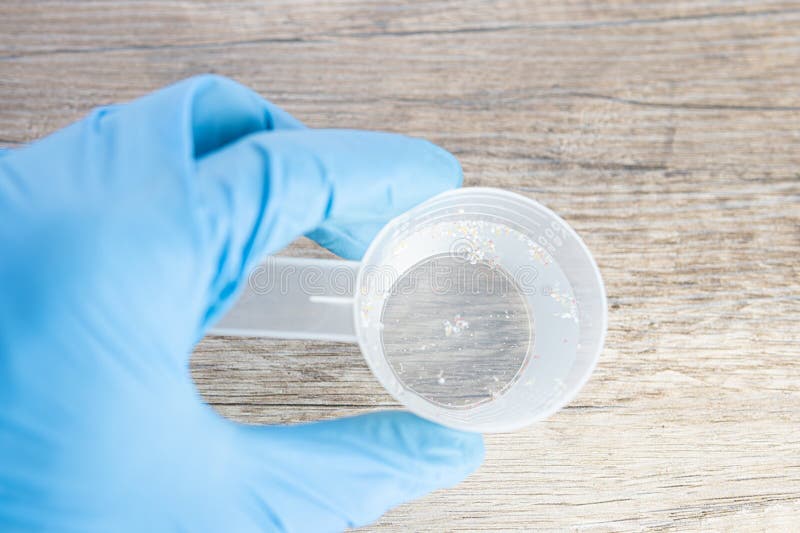 Microplastic Particles in Laboratory Water Sample. Gloved Researcher ...