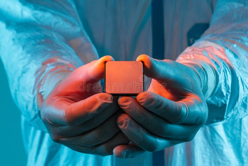 Microprocessor in Hands in Latex Gloves in a Sterile Suit Close-up. the ...