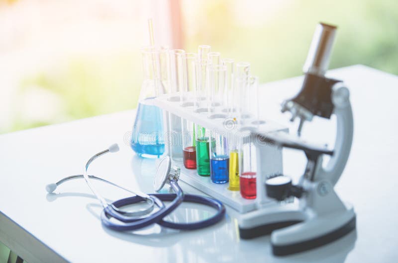 Microscope and Colorful Test Tubes on Table in Laboratory. Science ...