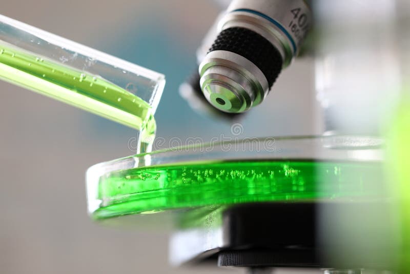 Microscope with Green Substance Pouring Out from Test Tube Stock Image ...