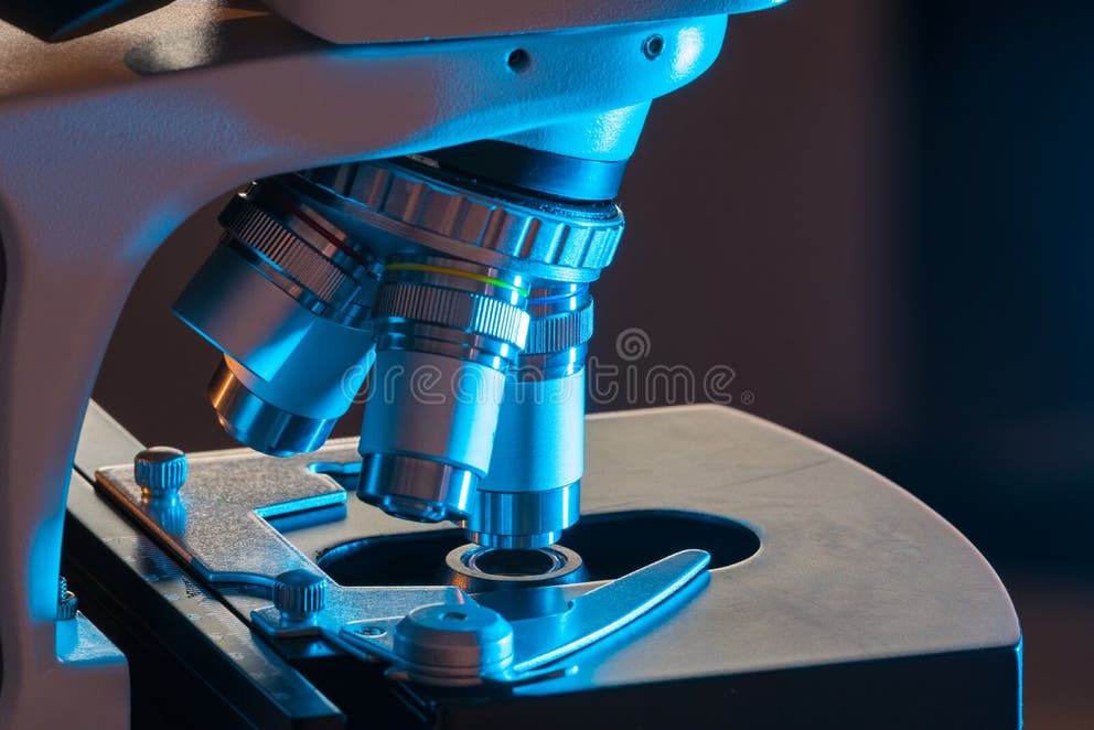 Microscope in Laboratory at Night in Blue Light. Microbiology and ...