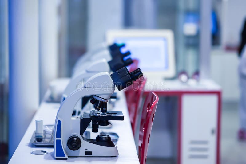 Microscope in Laboratory Table on Blur Background Stock Photo - Image ...