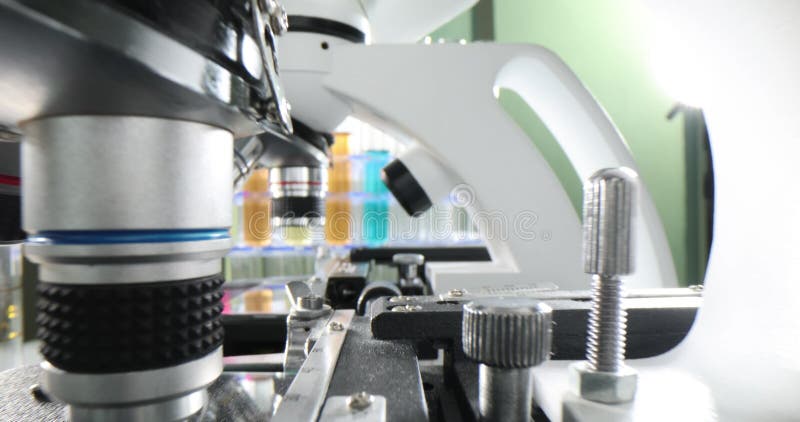 Microscope Lens in Laboratory Setting with Test Tubes Containing ...