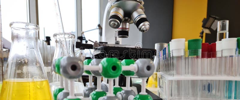 Microscope with Many Test Tubes and a Plastic Molecule Stock Photo ...