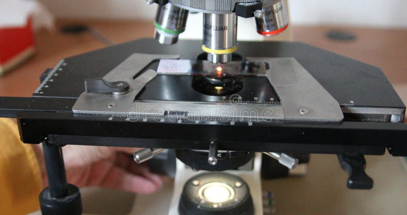Microscope with nosepiece stock video. Video of scientific - 201407545