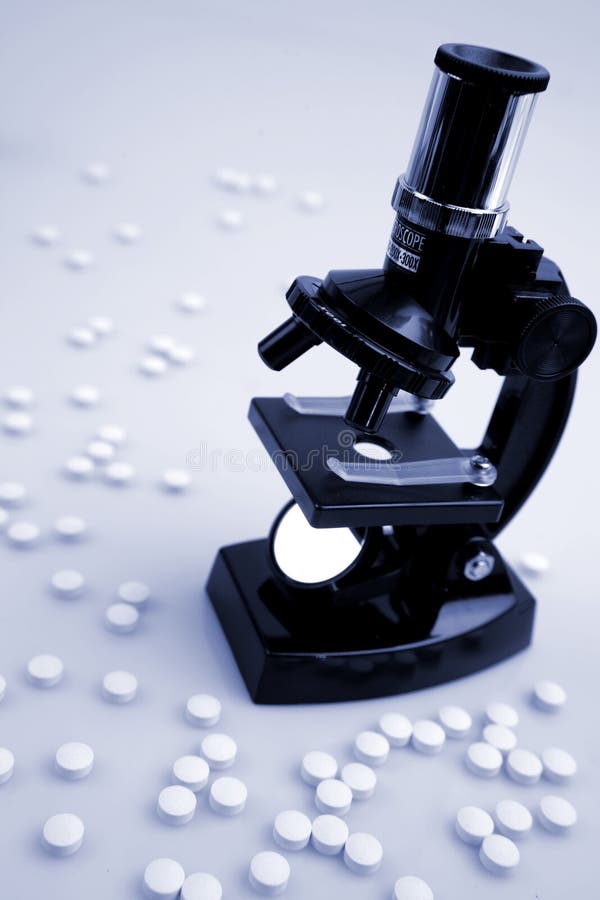 Microscope & pills stock image. Image of magnify, discover - 3227429