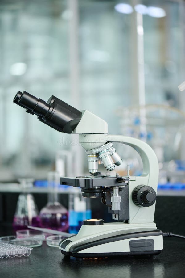 Microscope Standing Against Glassware Stock Photo - Image of workplace ...