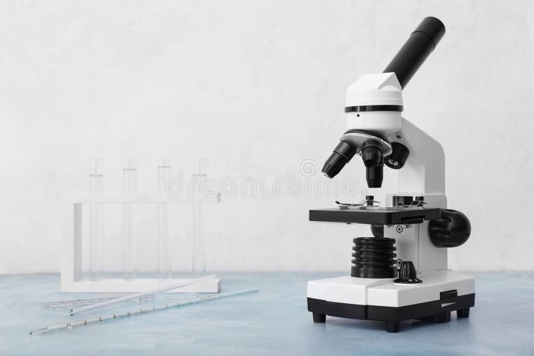 Modern Microscope on Table Against Light Background Stock Photo - Image ...