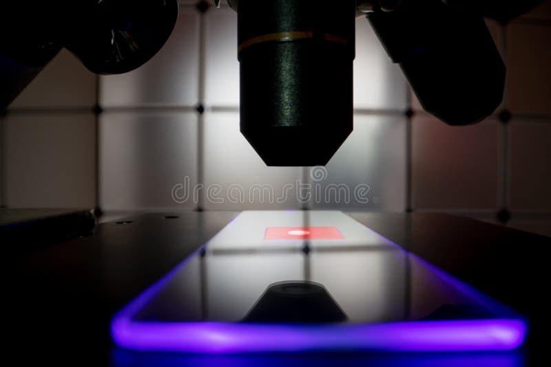 Microscope Table with a Luminous Slide and a Microscope Lens on a Dark ...