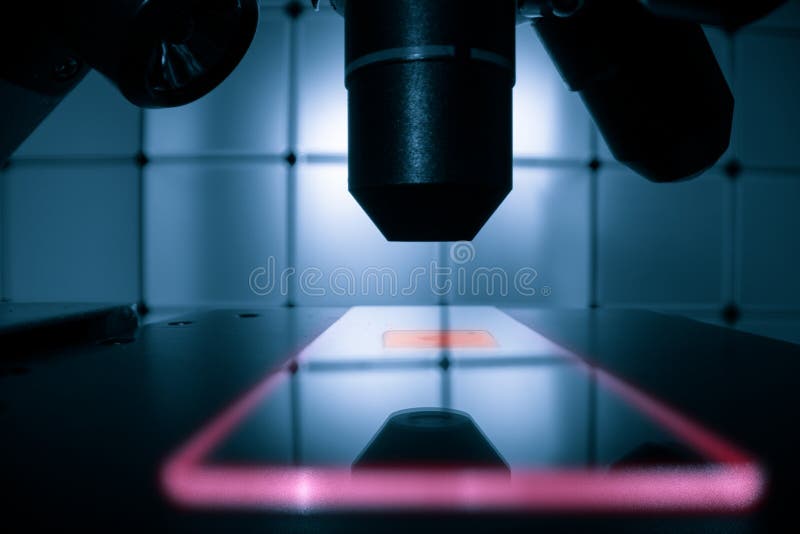 Microscope Table with a Luminous Slide and a Microscope Lens on a Dark ...
