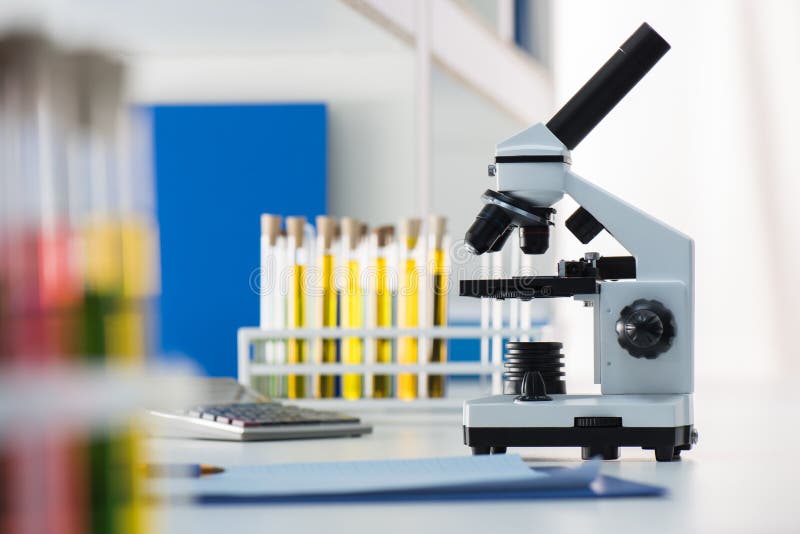 Microscope and test tubes stock image. Image of table - 90085541