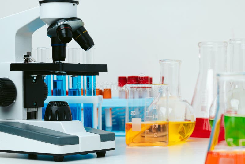 Microscope and Test Tubes on Table in Laboratory, Close Up Stock Photo ...