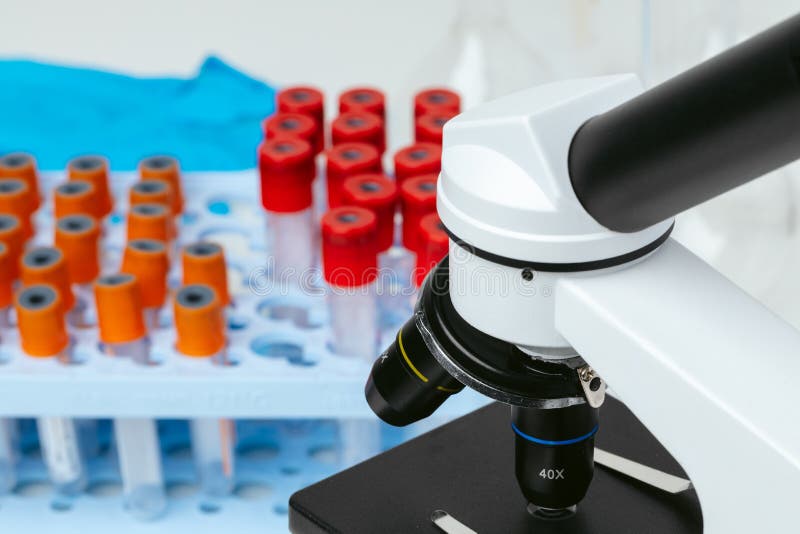 Microscope and Test Tubes on Table in Laboratory, Close Up Stock Photo ...