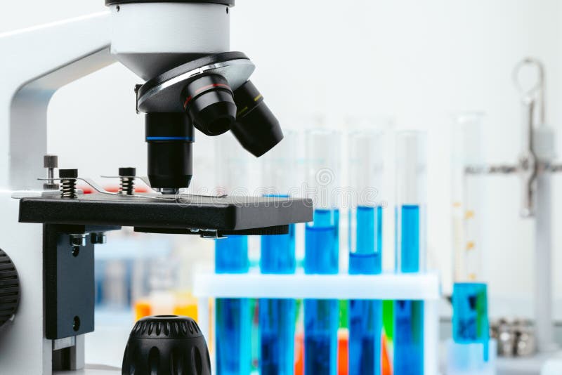 Microscope and Test Tubes on Table in Laboratory, Close Up Stock Photo ...