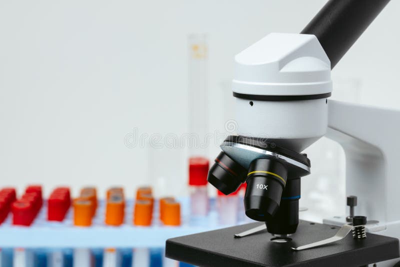 Microscope and Test Tubes on Table in Laboratory, Close Up Stock Photo ...