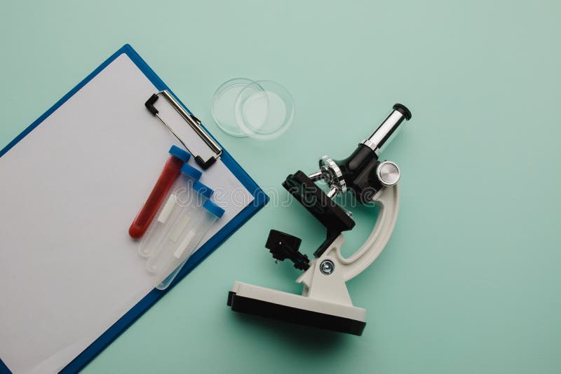 Microscope, Test Tubes and Watch Glass on a Blue Background. Laboratory ...