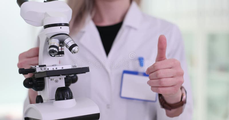 Microscopic Analysis and Quality Control Scientist Holding a Microscope ...