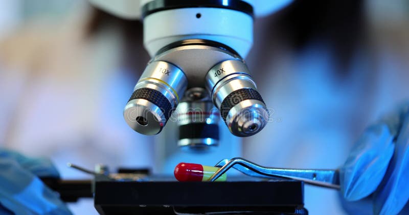 Microscopic Analysis of a Red and Yellow Capsule Stock Footage - Video ...