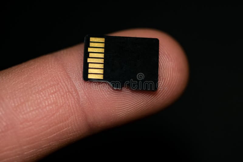 Microsd Card on Human Finger Over Black Background,hi Tech Data Storage ...