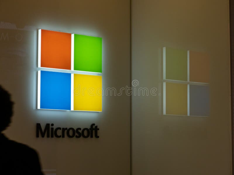Microsoft Logo and Reflect with Man Walking by in Shadow Editorial ...