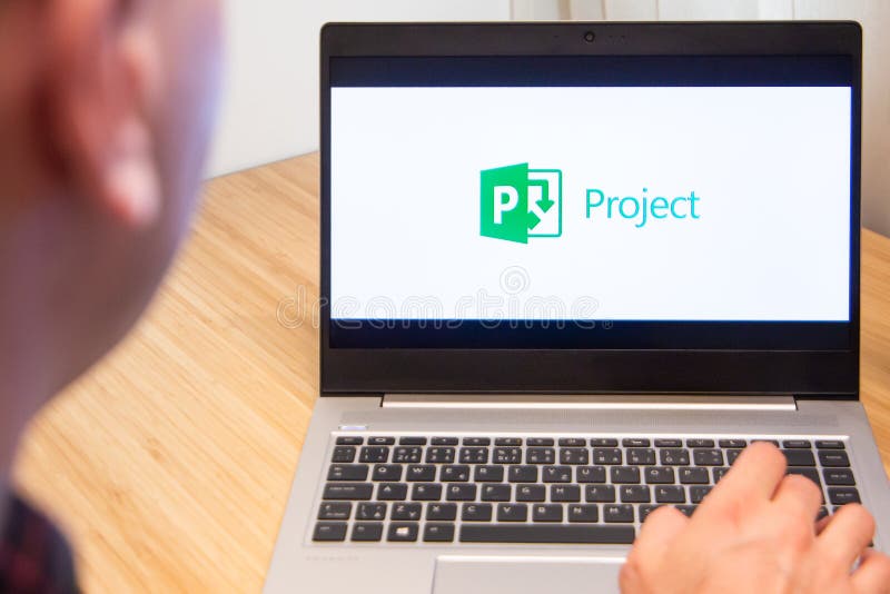 Microsoft Project is Used by a Man on the Laptop. Microsoft Customer ...