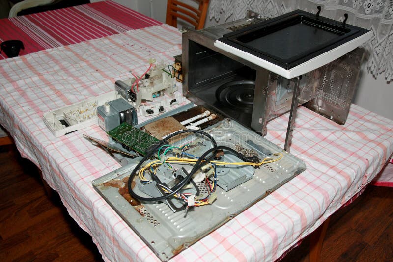 Microwave Oven Disassembled on a Kitchen Table Stock Photo - Image of ...