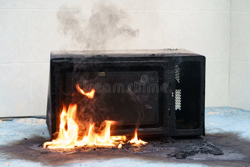 Microwave Oven on Fire. the Concept of Fire in the Kitchen. Stock Image ...