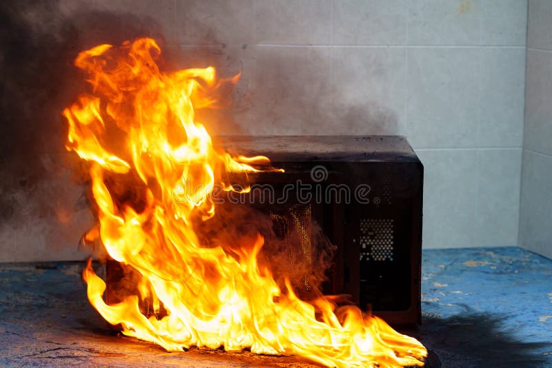 Microwave Oven on Fire. the Concept of Fire in the Kitchen. Stock Image ...