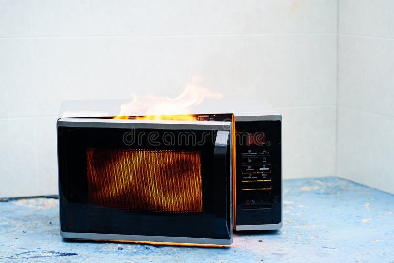 Microwave Oven on Fire. the Concept of Fire in the Kitchen. Stock Photo ...