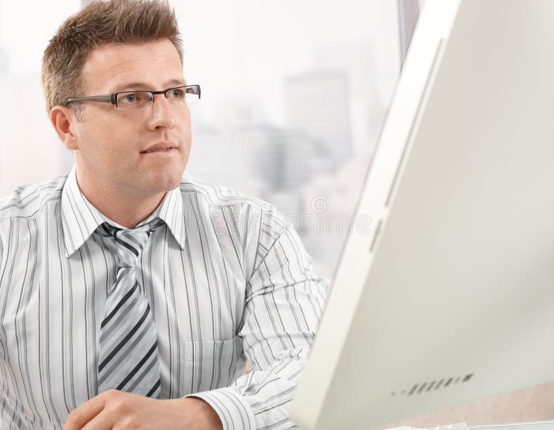Mid-adult Businessman Looking at Computer Screen Stock Image - Image of ...