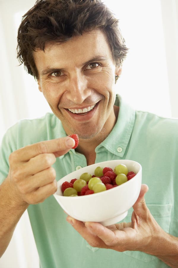 Mid Adult Man Eating Fresh Fruit Stock Image - Image of enjoyment ...