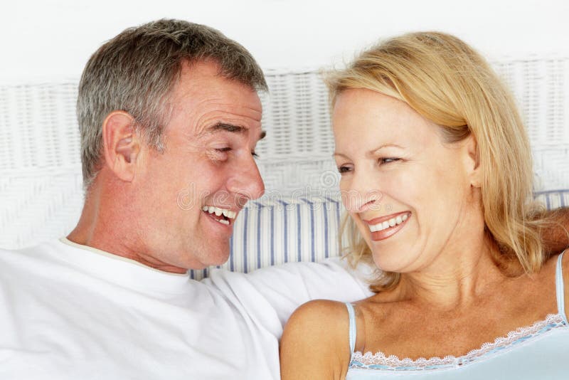 Middle Aged Couple with Heads Together Stock Image - Image of ...
