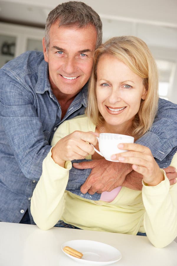 Happy Mid Age Couple at Home Stock Image - Image of home, looking: 21030267