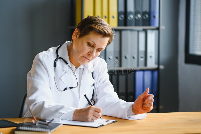 Mid Age Female Doctor Writing Prescription Stock Photo - Image of ...